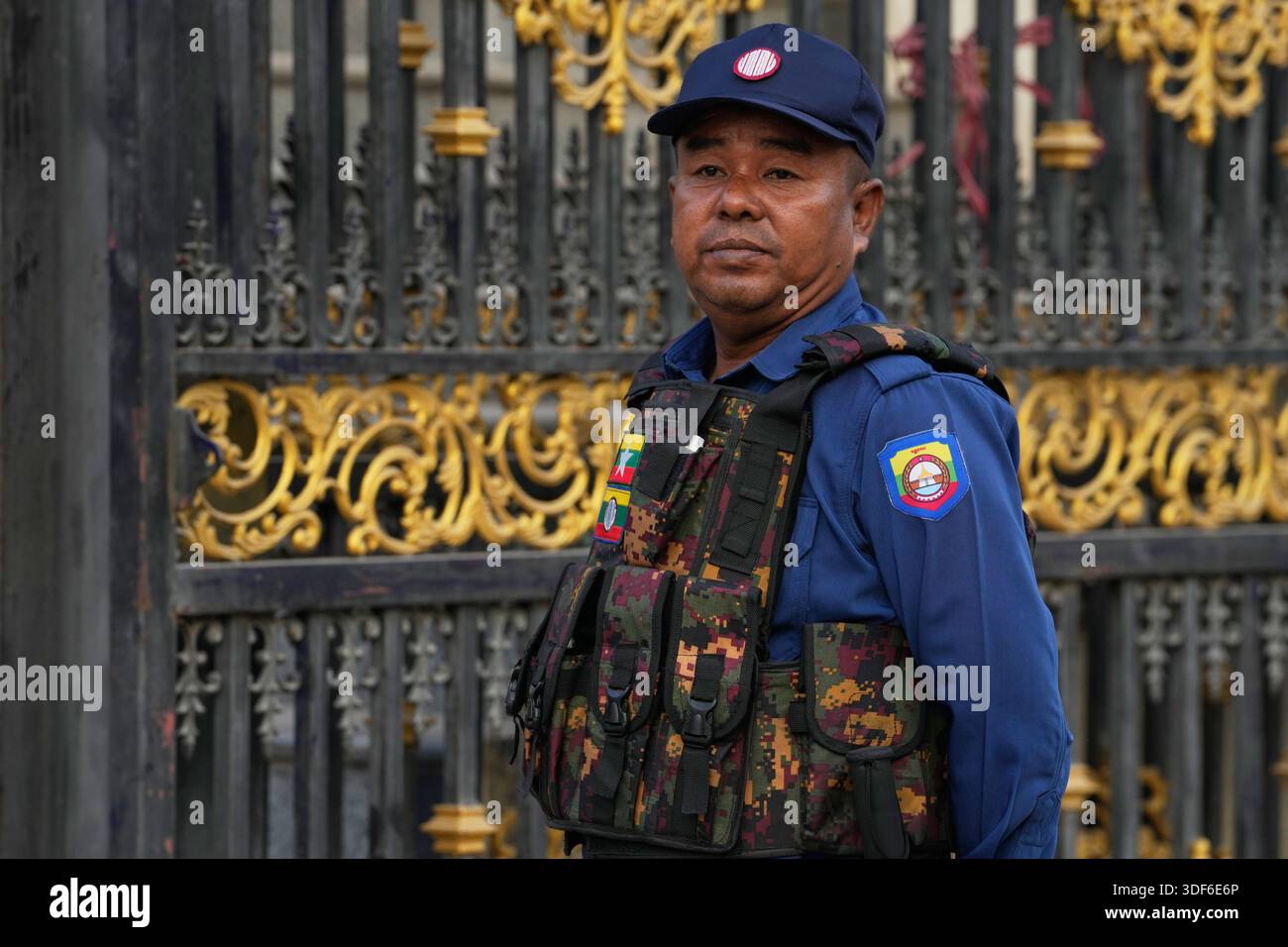 A member of military-affiliated militia stands guard in front of a ...