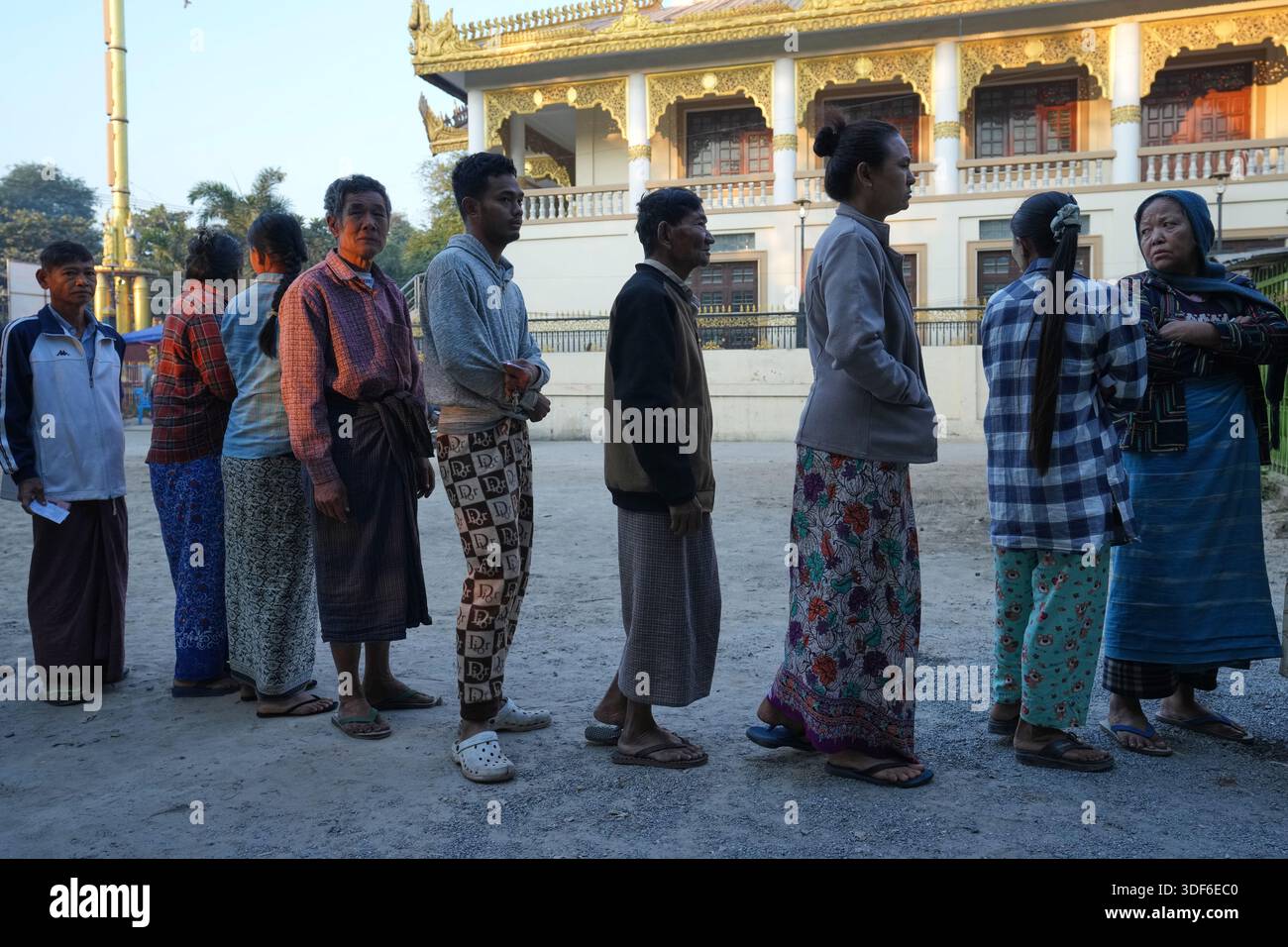 Voters line up to cast their ballots at a polling station during the ...