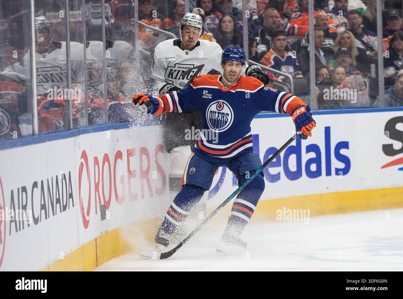 Los Angeles Kings' Andre Lee, left, is checked by Edmonton Oilers' Evan ...