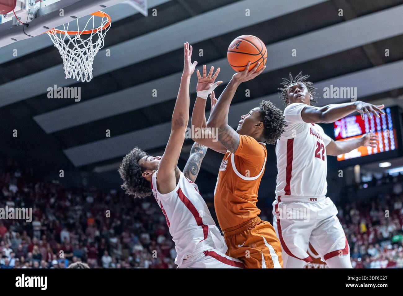 Texas guard Dailyn Swain gets a shot off between Alabama guard Houston ...