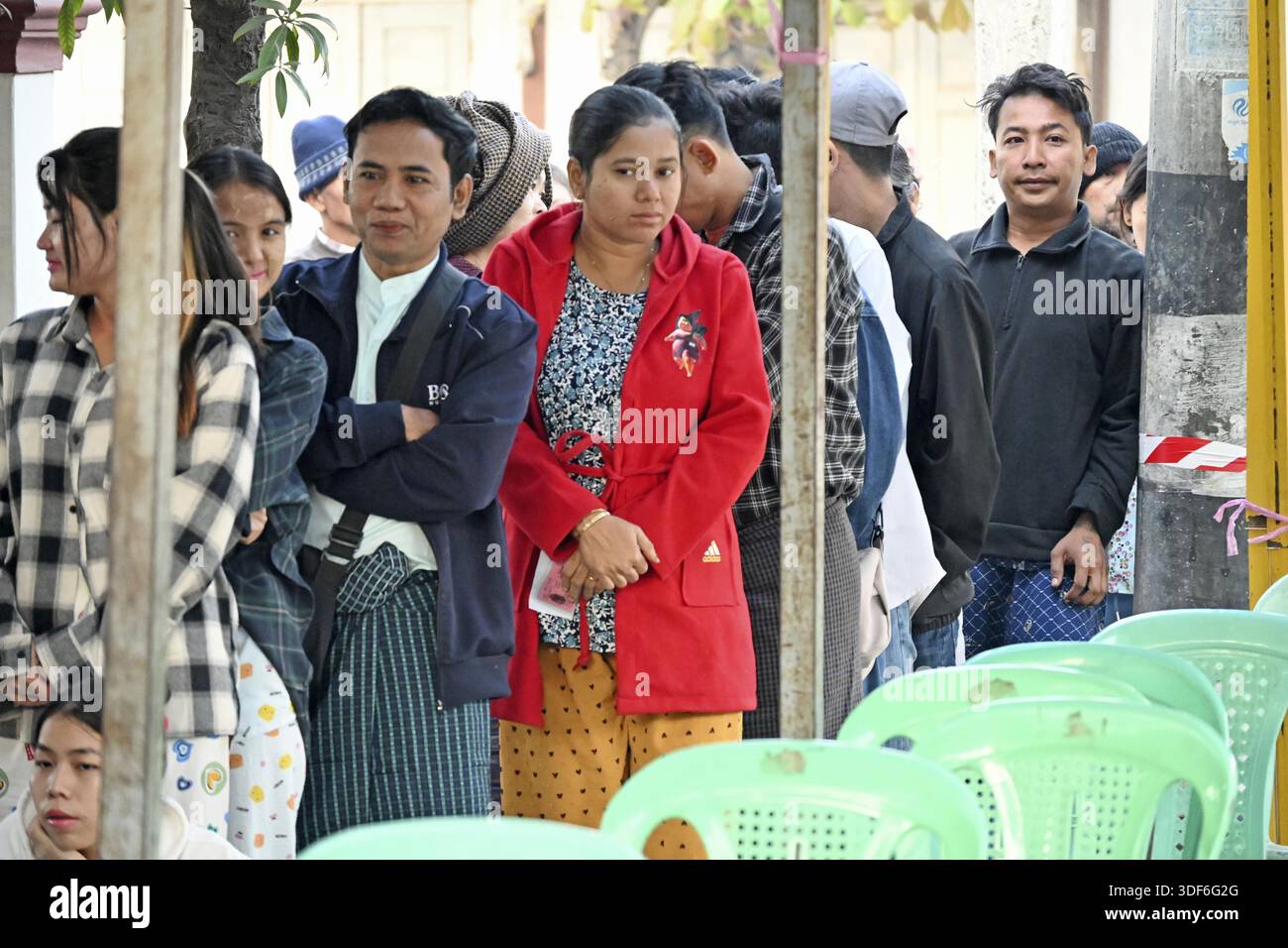 Voters queue at a polling station in Mandalay, Myanmar, on Jan. 11 ...