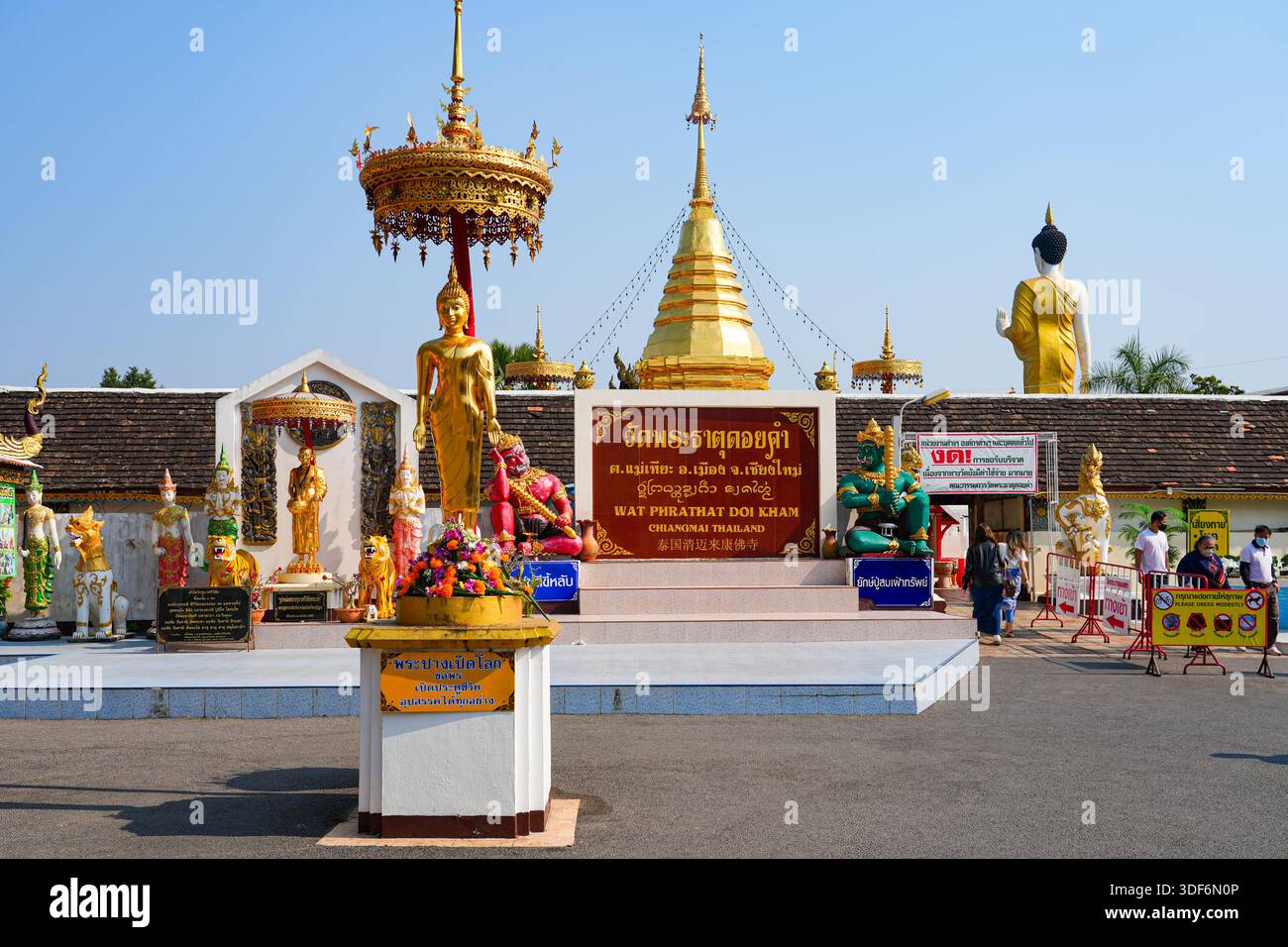 Main entrance and golden chedi of Wat Phra That Doi Kham temple on the ...
