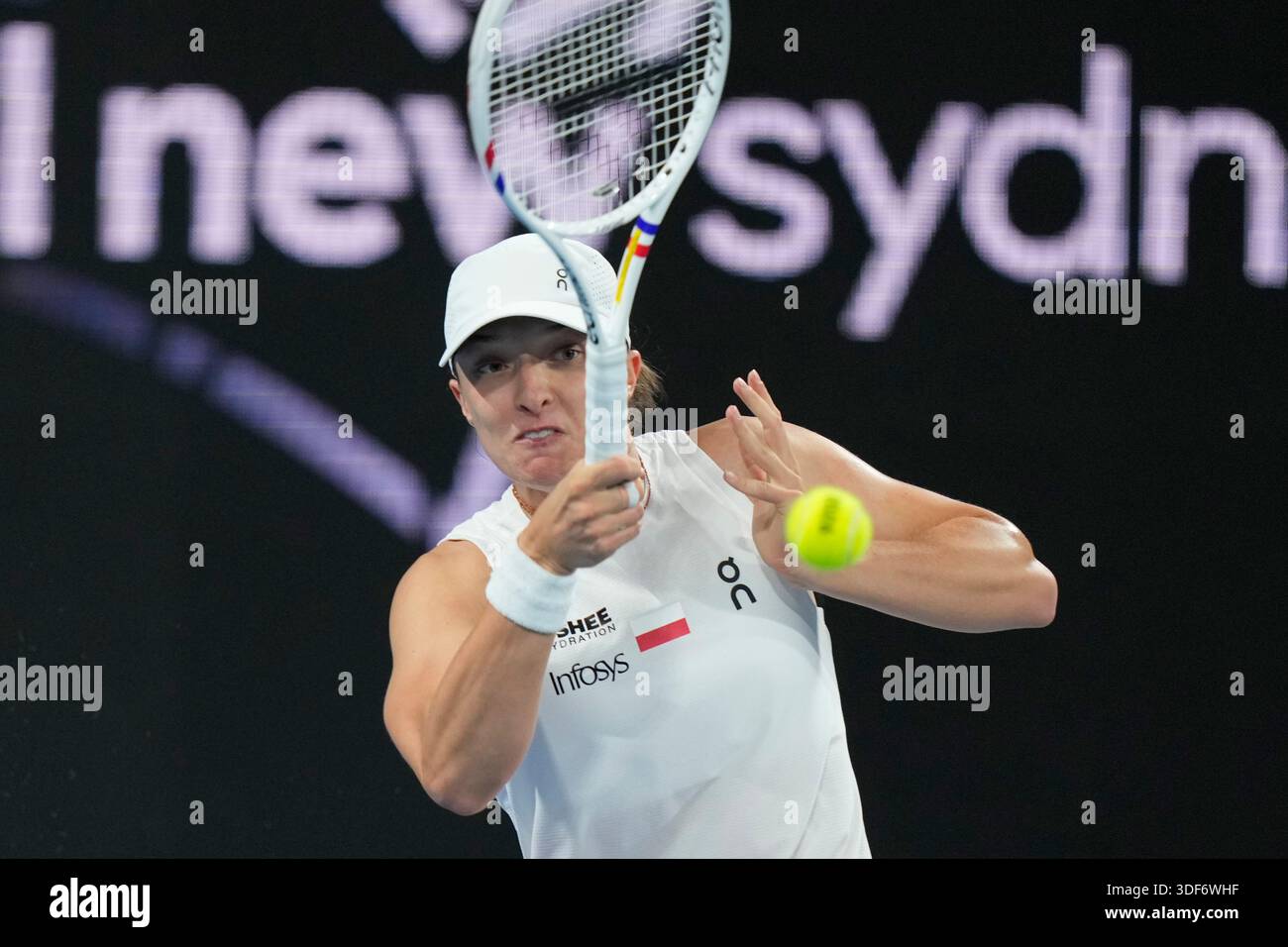 Iga Swiatek of Poland hits a forehand to Belinda Bencic of Switzerland ...