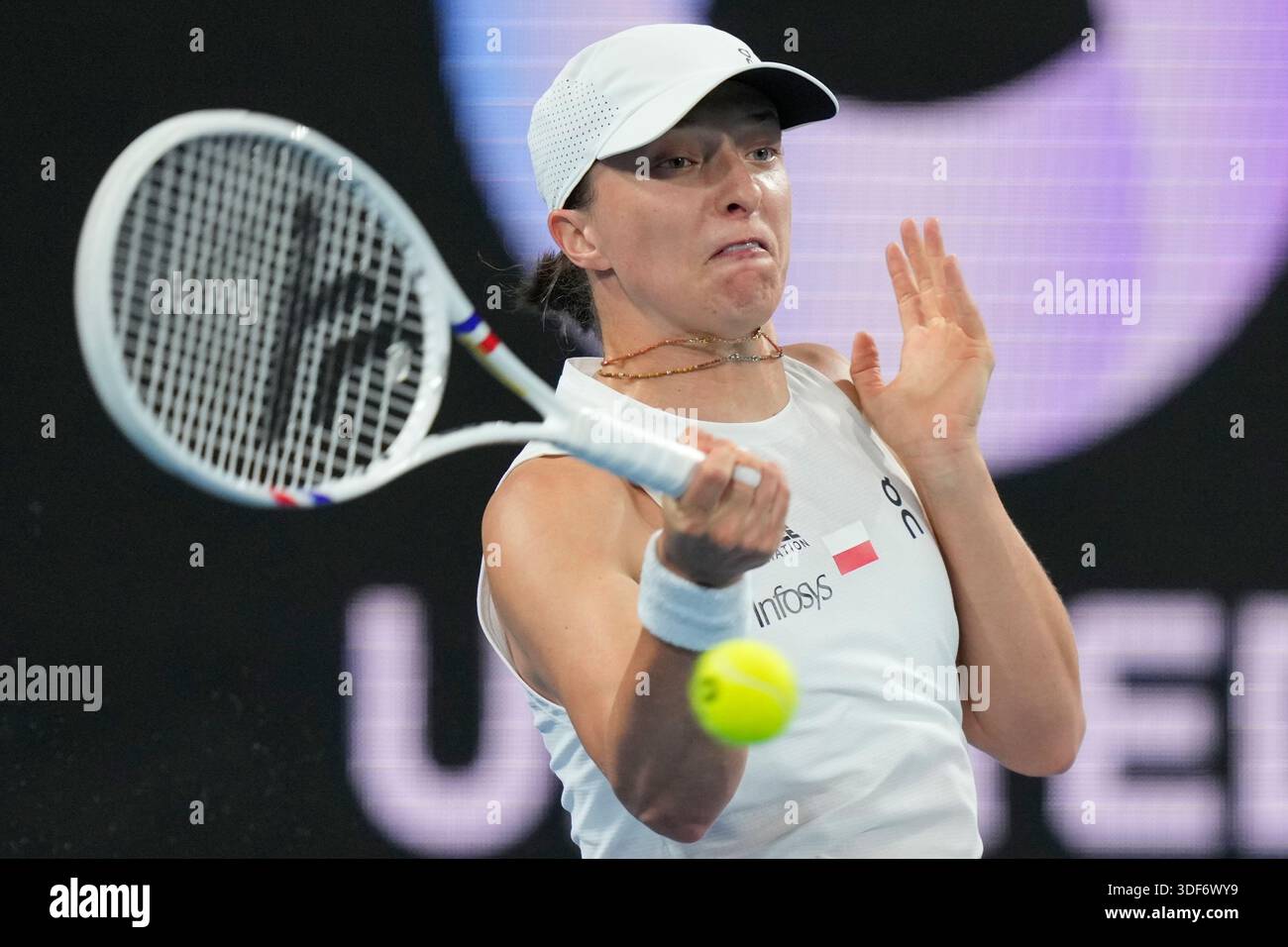 Iga Swiatek of Poland hits a forehand to Belinda Bencic of Switzerland ...
