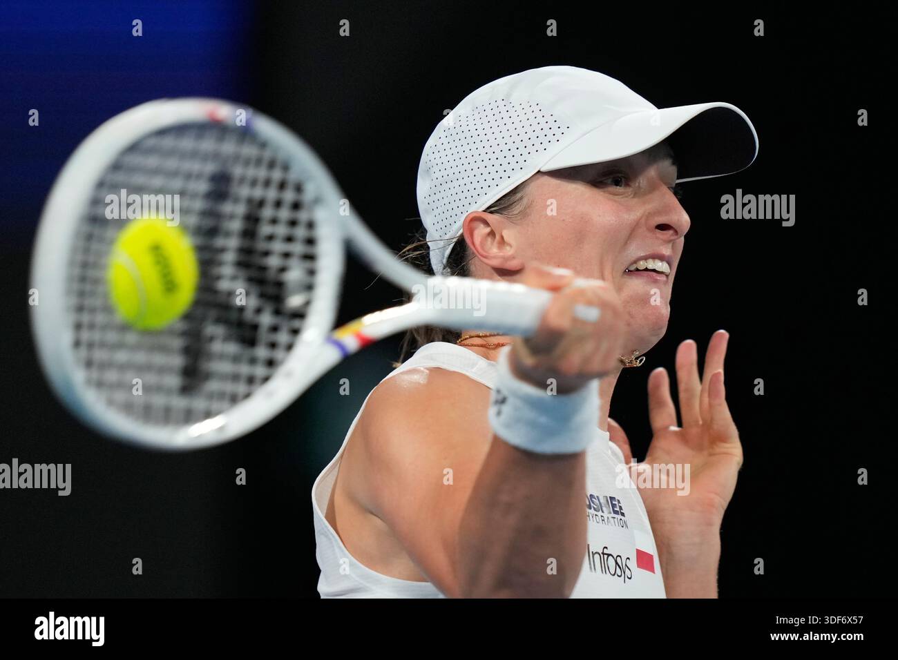 Iga Swiatek of Poland hits a forehand to Belinda Bencic of Switzerland ...