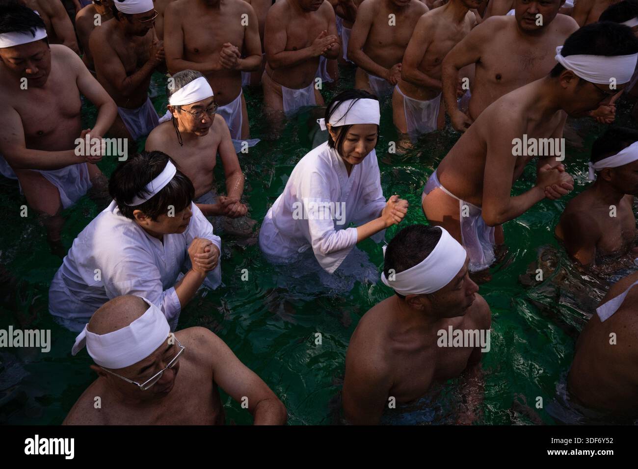 Participants bath in ice-cold water to purify their souls and pray for ...