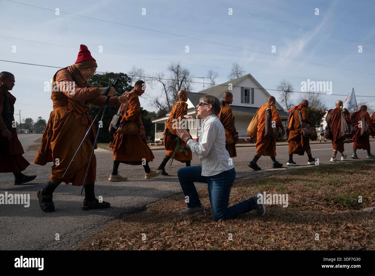 Audrie Pearce greets Buddhist monks who are participating in the, "Walk ...