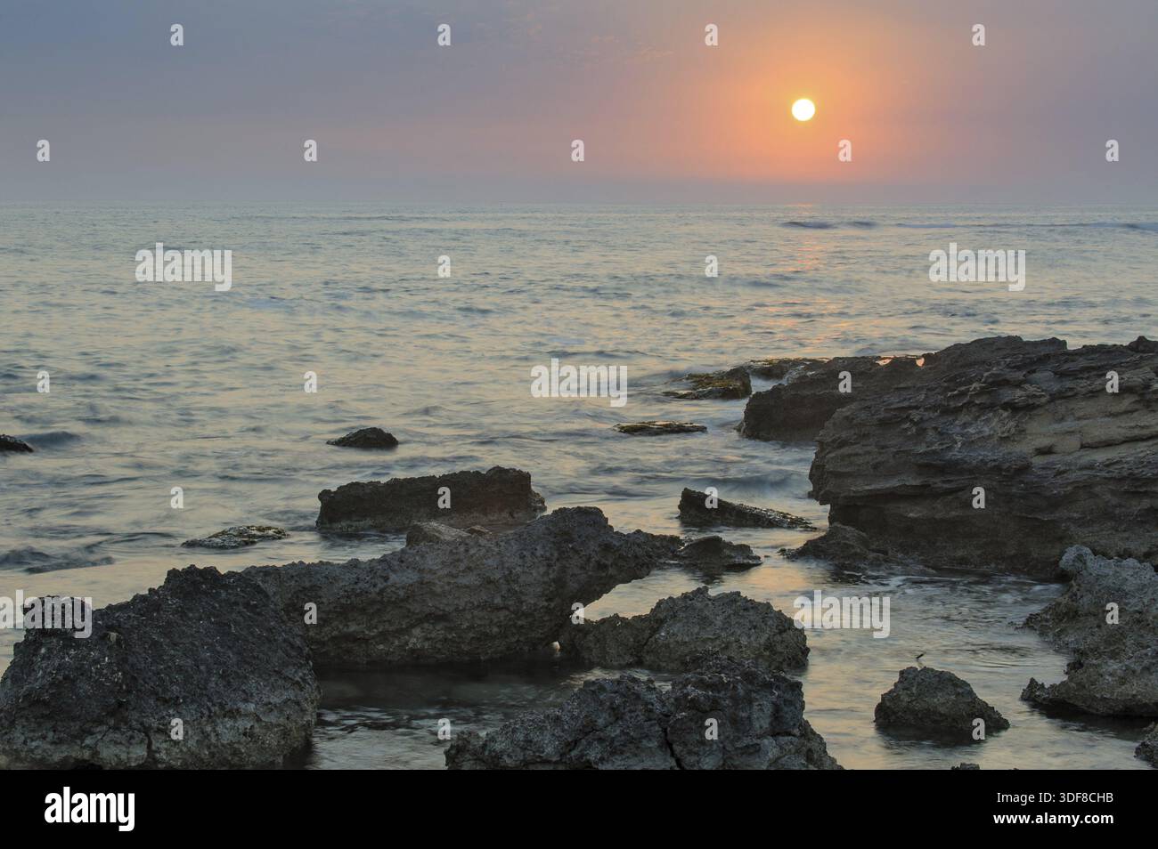 Sunset over rocky coastline hi-res stock photography and images - Alamy