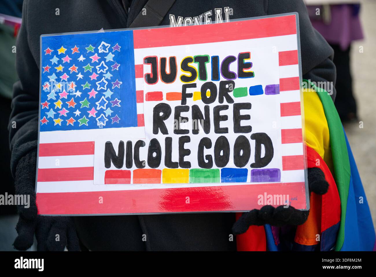 11 January 2026, Berlin: A participant in a vigil for the shot American ...