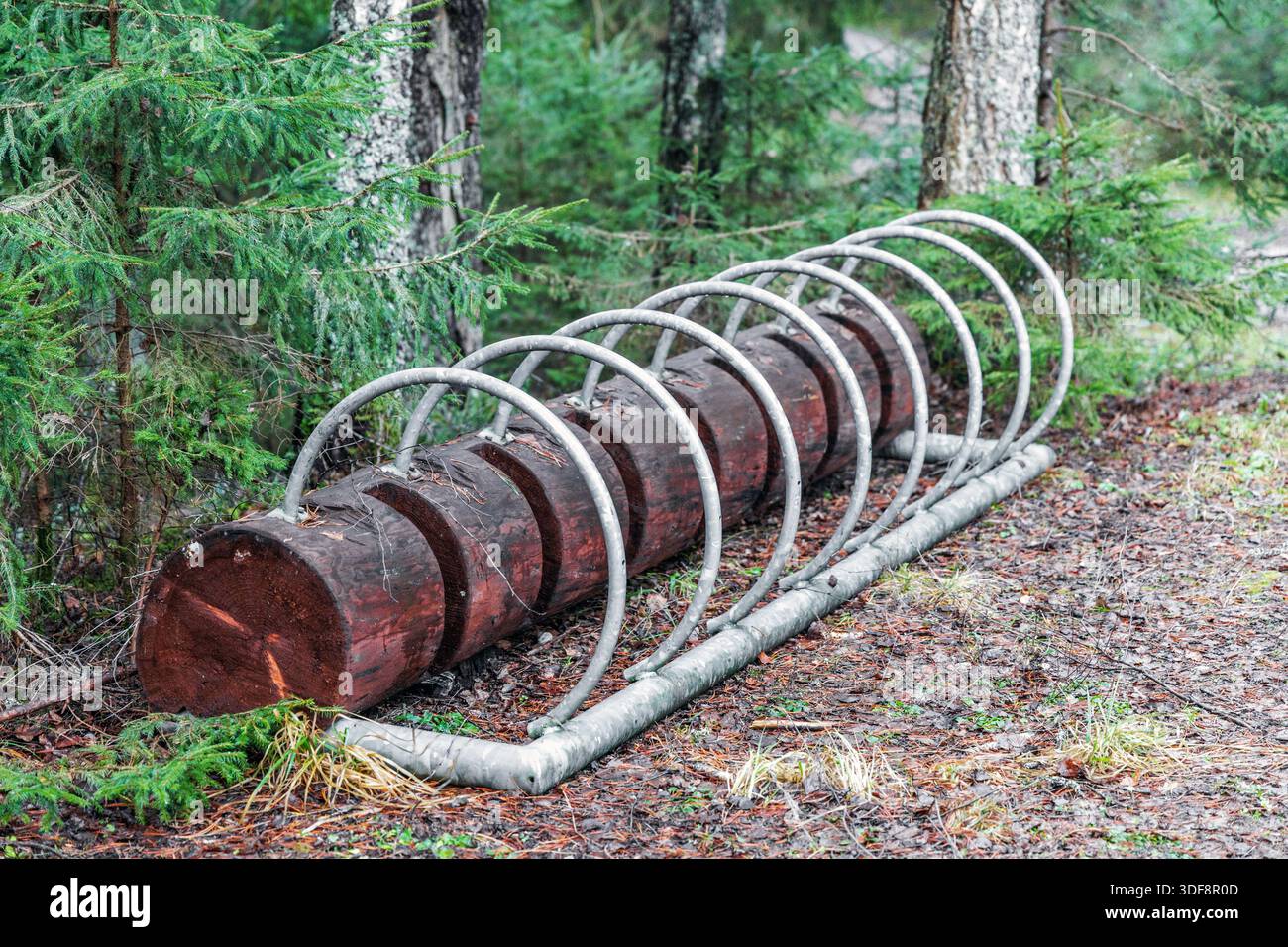 Creative eco-friendly bike stand made from a solid tree log with metal ...