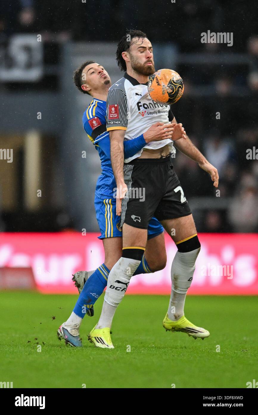 Ben Brereton of Derby County is held by Ethan Ampadu of Leeds United ...