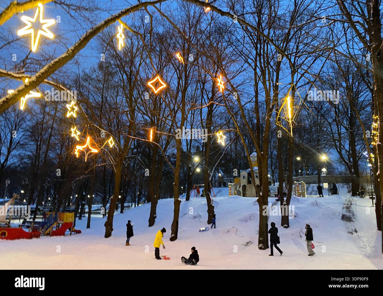 11 January 2026, Latvia, Riga: People ride down the hill on sledges at ...