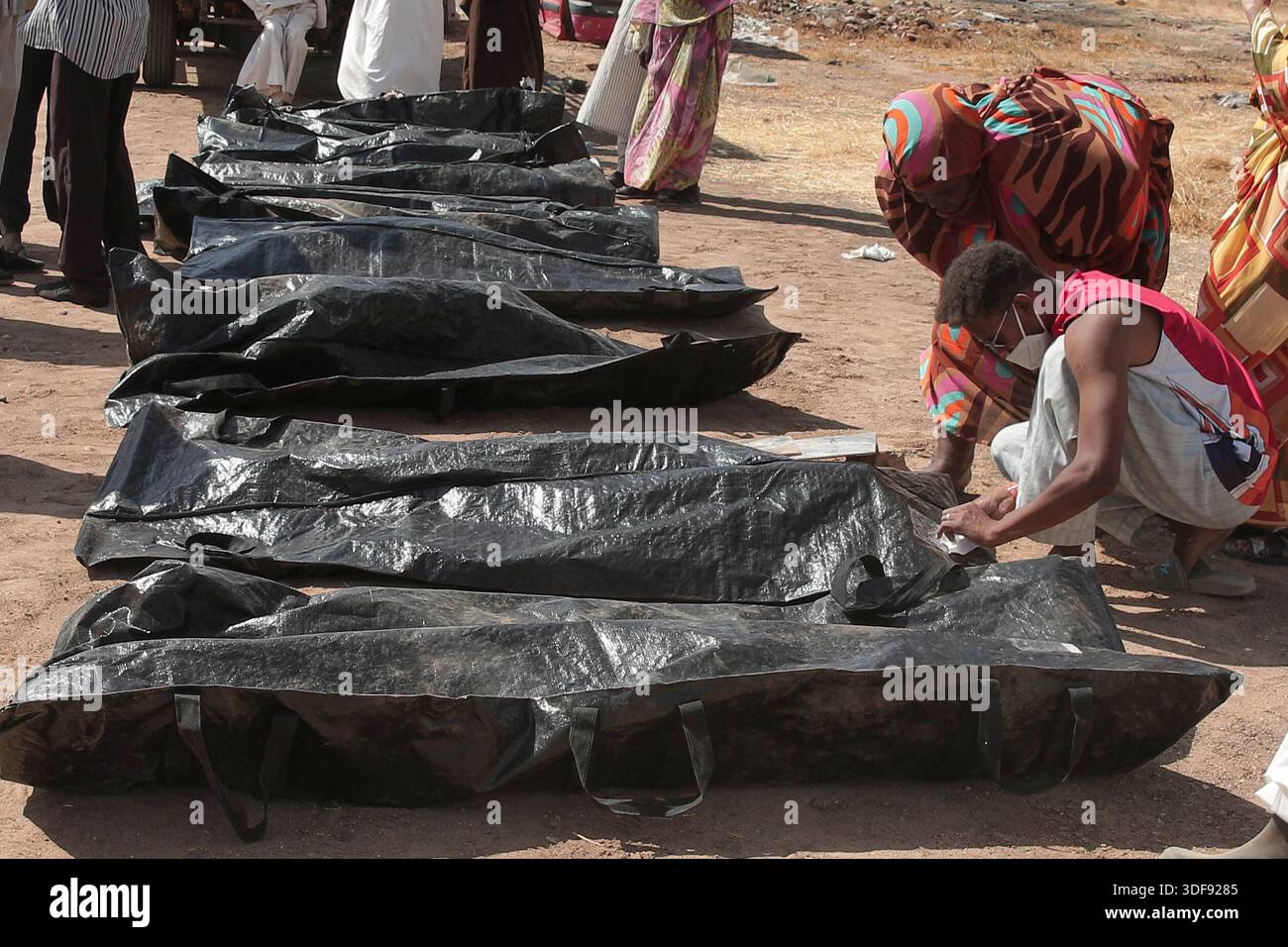 Relatives check names on body bags of victims of Sudan’s two-year ...