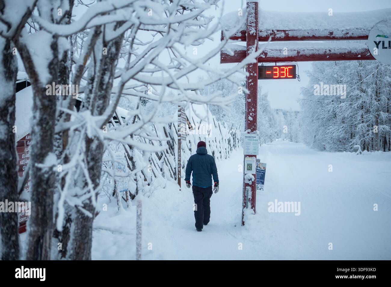 A person walks past a digital display showing a temperature of minus 33 ...