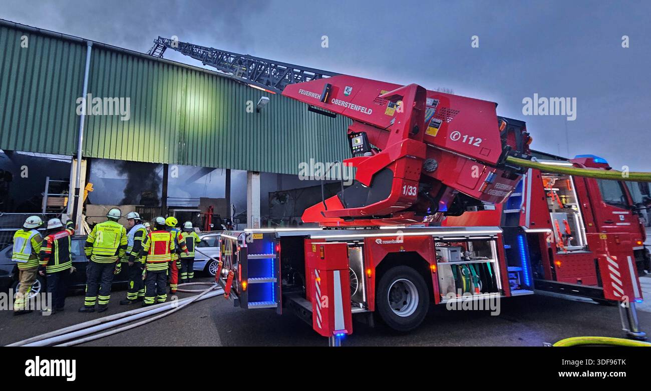 11 January 2026, Baden-Württemberg, Oberstenfeld: Firefighters use a ...