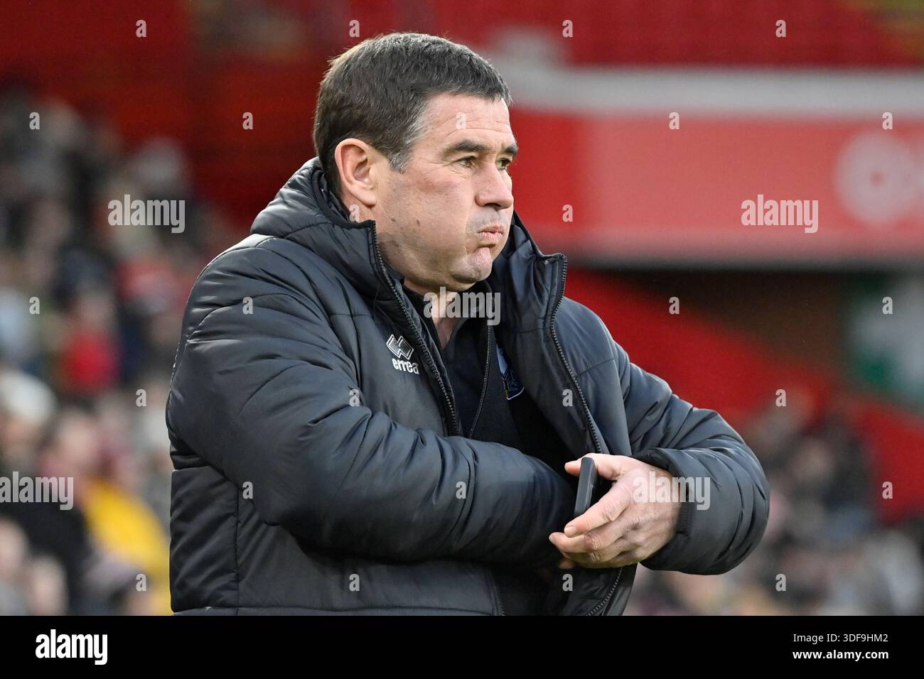 Nigel Clough Manager of Mansfield Town puffs his breath during the ...