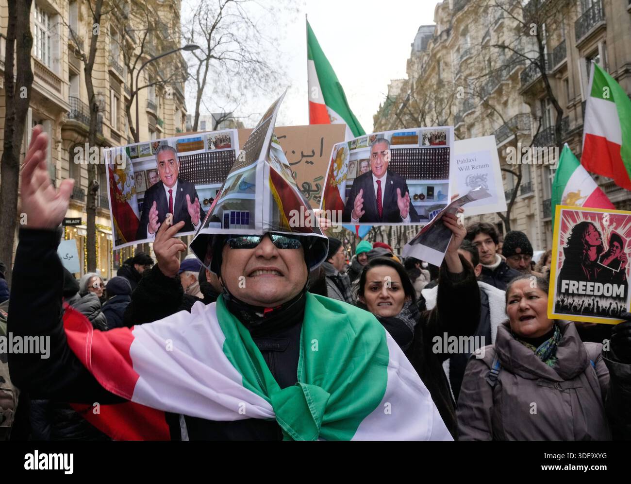Protesters march with posters of Reza Pahlavi during a rally in support ...