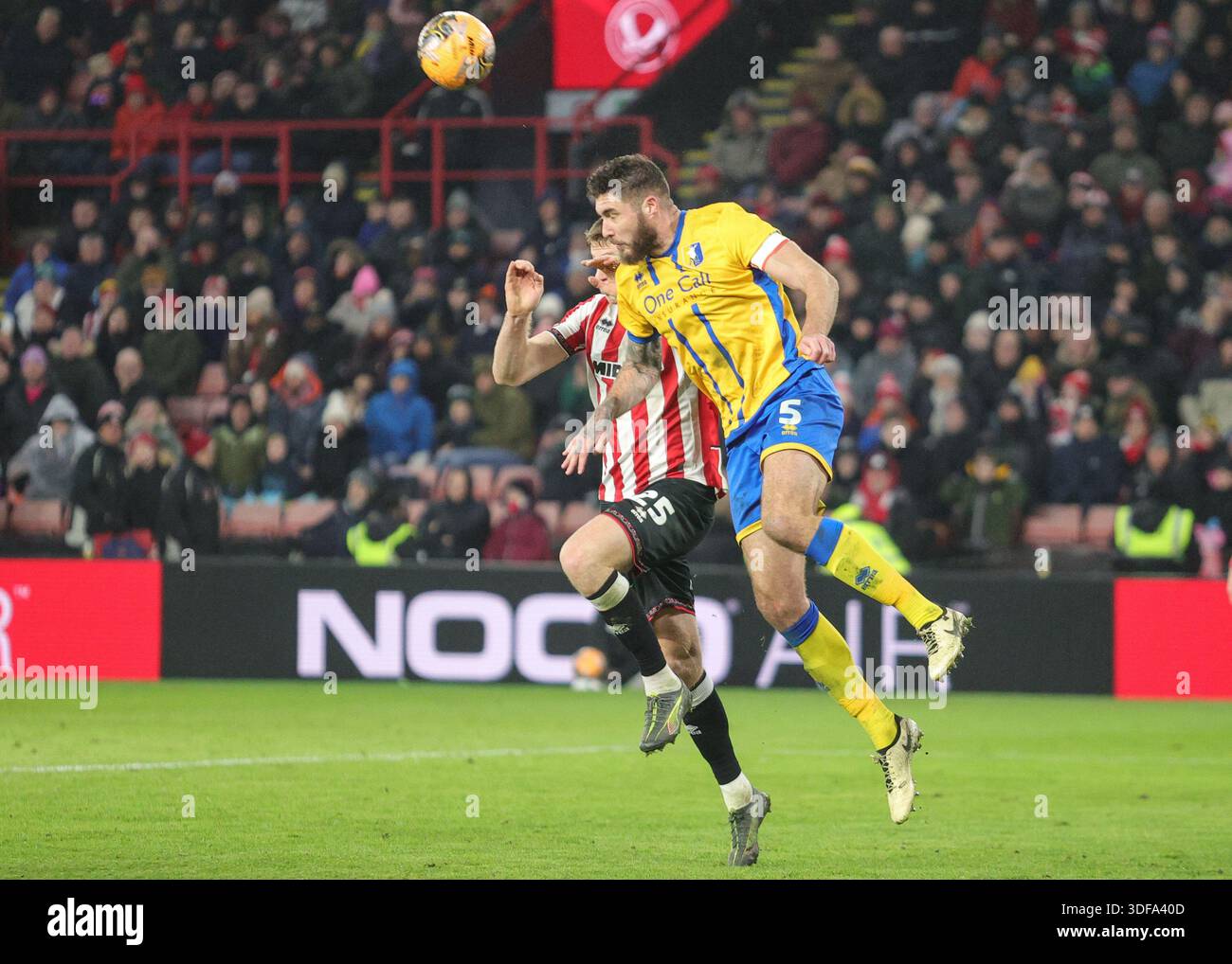 Ryan Sweeney of Mansfield Town heads the ball clear during the Emirates ...