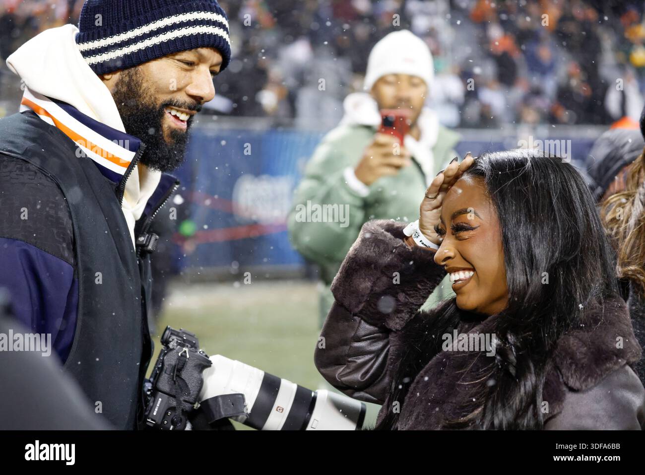 Common the rapper, left, and Simon Biles before an NFL wild-card ...