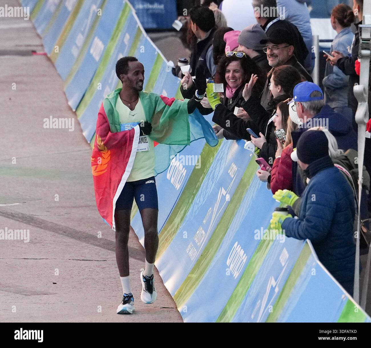 Habtom Samuel, left, of Ethiopia, celebrates after his first-place ...