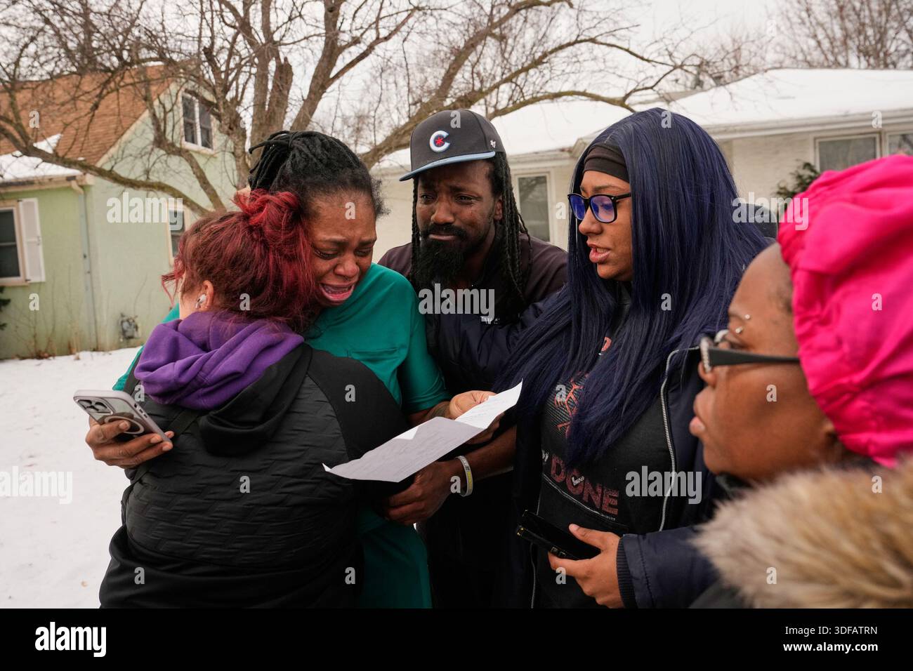 A family member reacts after federal immigration officers make an ...