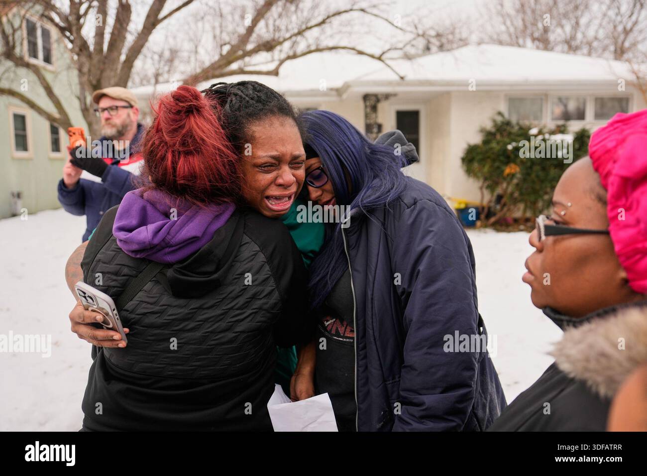 A family member reacts after federal immigration officers make an ...