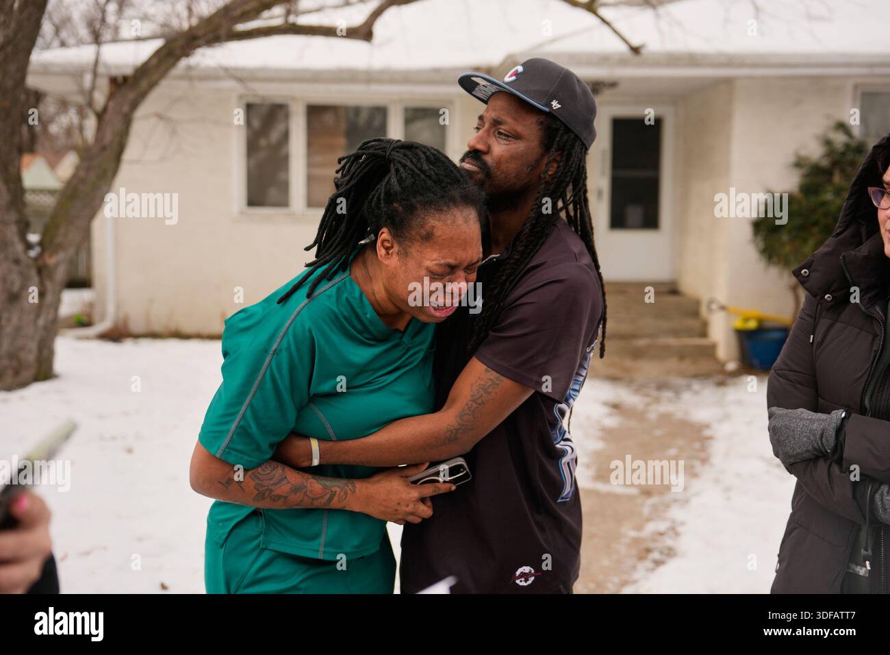 A family member reacts after federal immigration officers make an ...