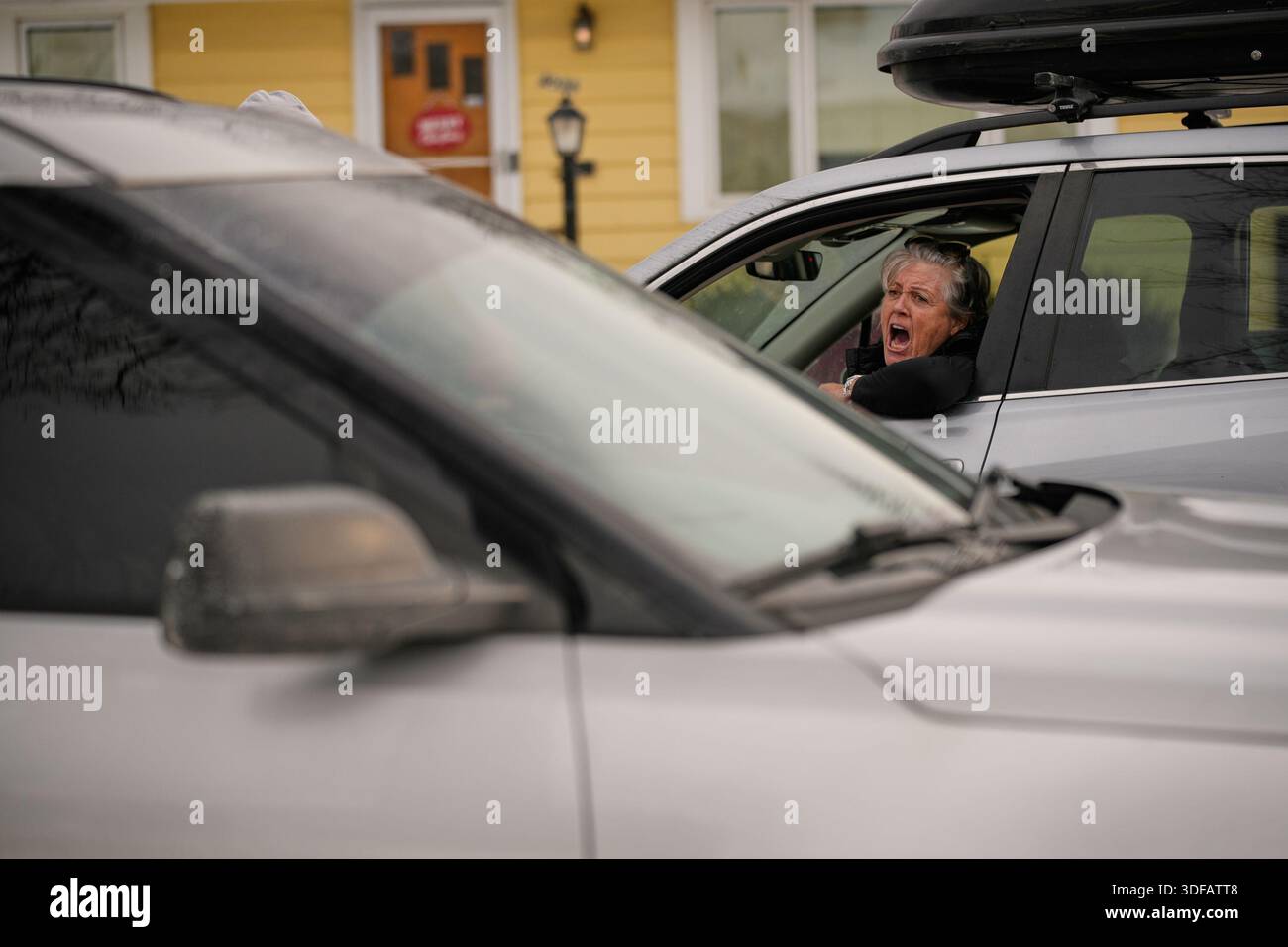 A woman yells at federal immigration officers as they make an arrest ...