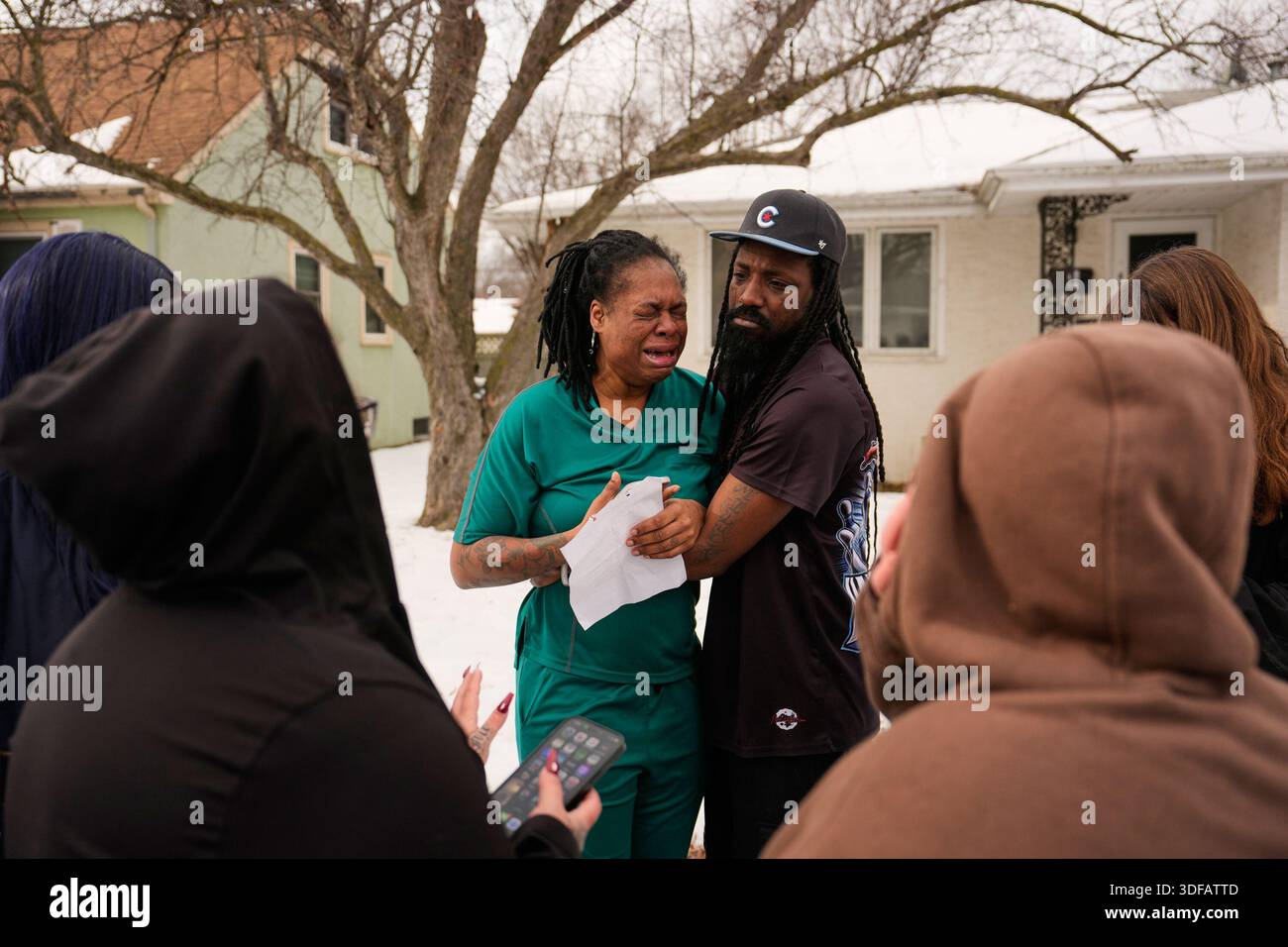 A family member reacts after federal immigration officers make an ...