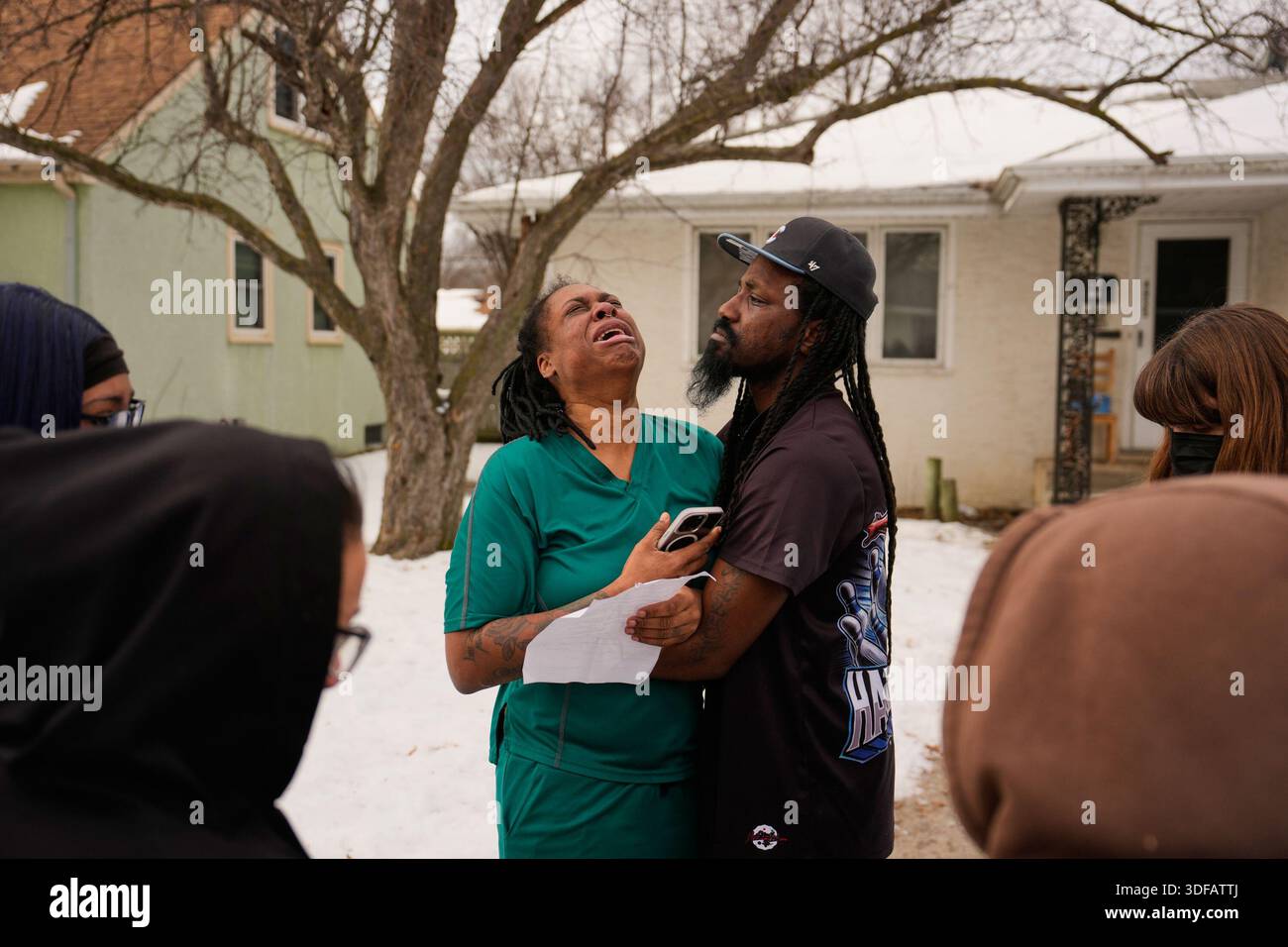 A family member reacts after federal immigration officers make an ...