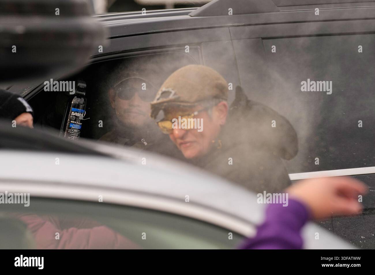 A federal immigration officer deploys pepper spray as officers make an ...