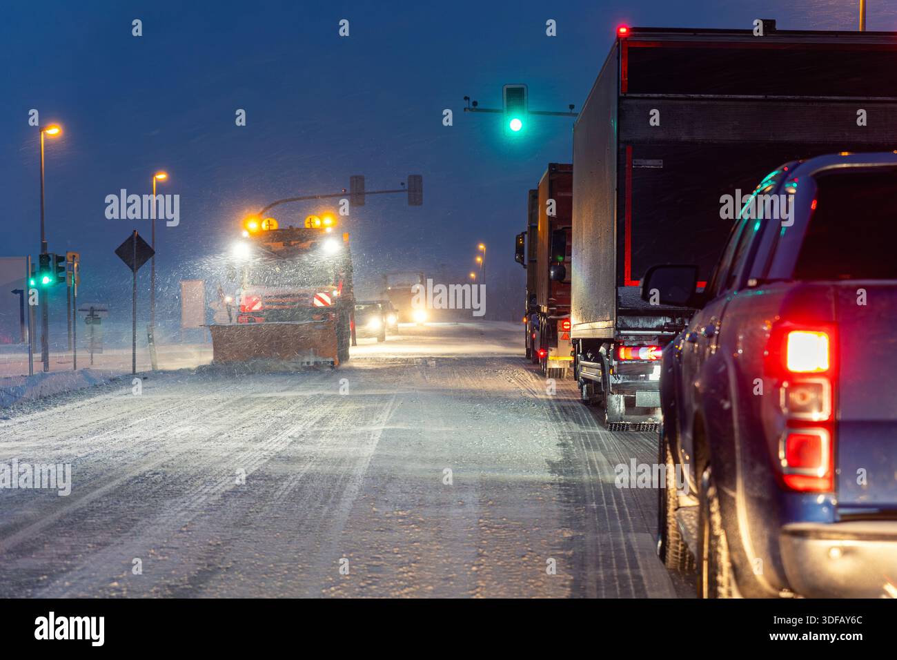 Night winter road scene heavy snowfall snowplow truck clearing icy ...