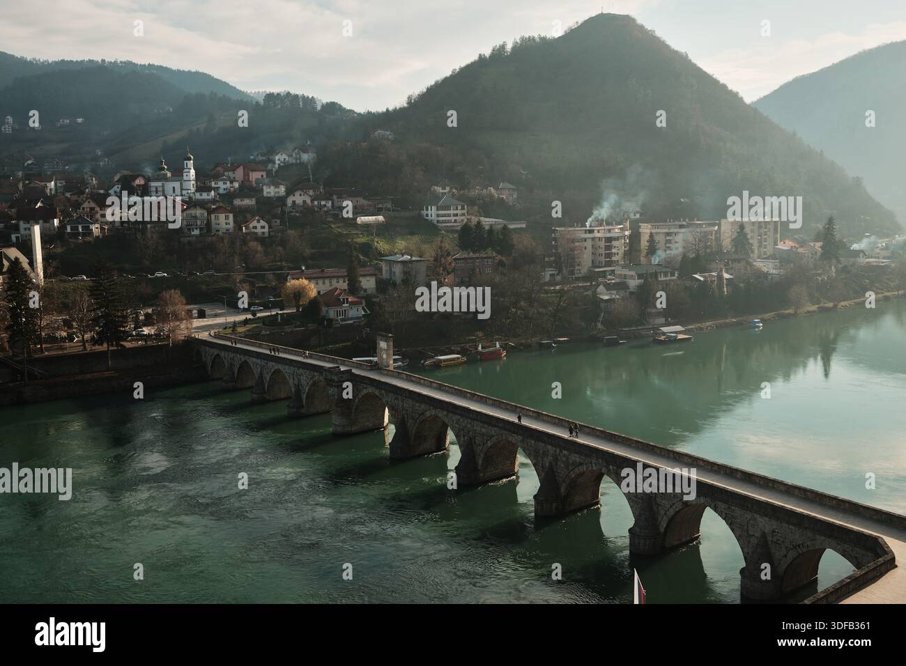 Elevated view shows the historic stone bridge crossing the Drina River ...