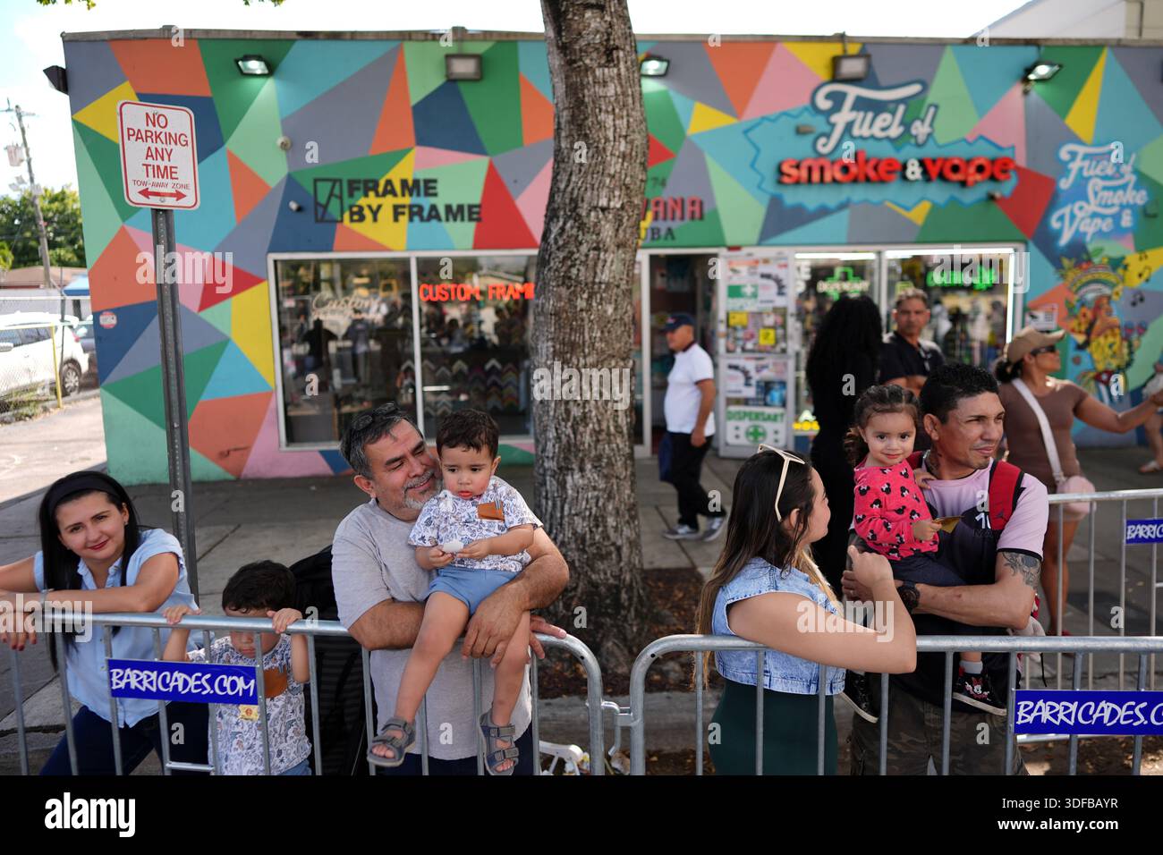 Spectators stand along the route of a weekend parade celebrating ...