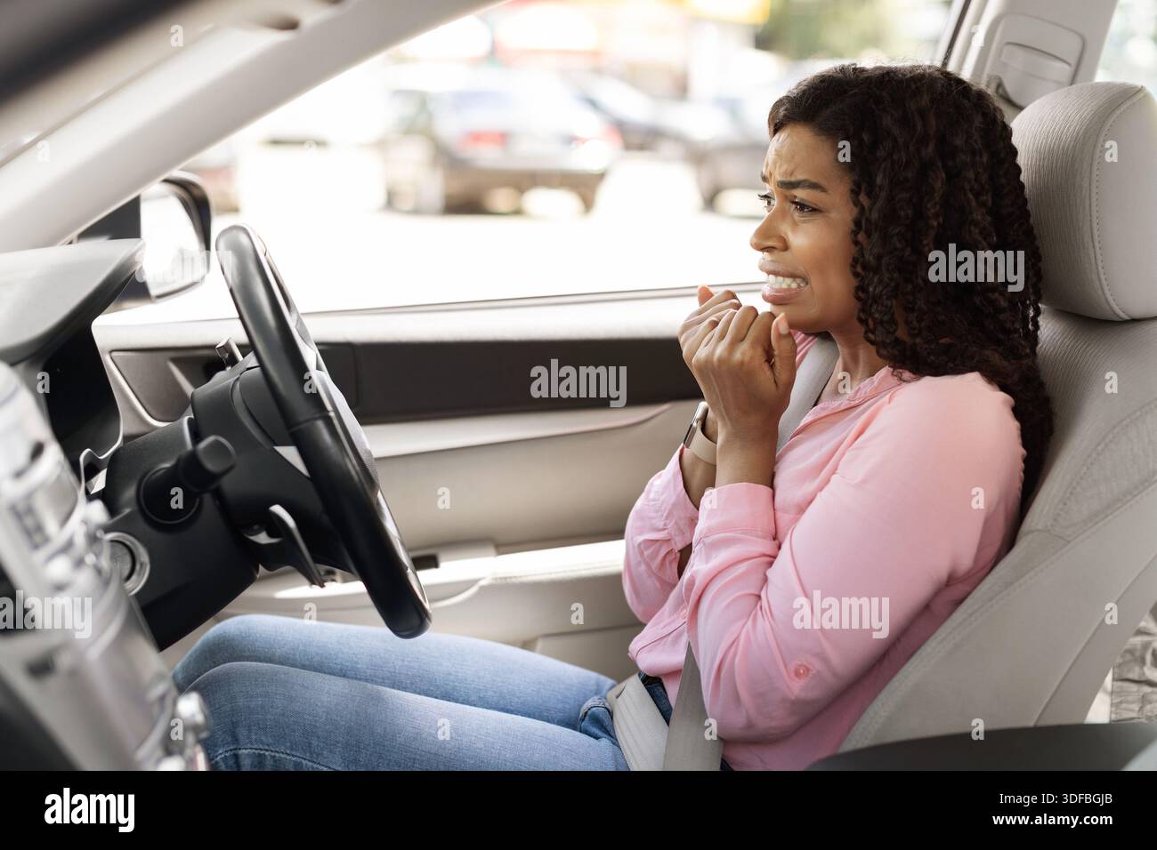 Scared black woman driving car, had an accident Stock Photo - Alamy