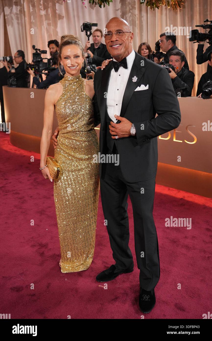 Lauren Hashian, left, and Dwayne Johnson arrive at the 83rd Golden ...