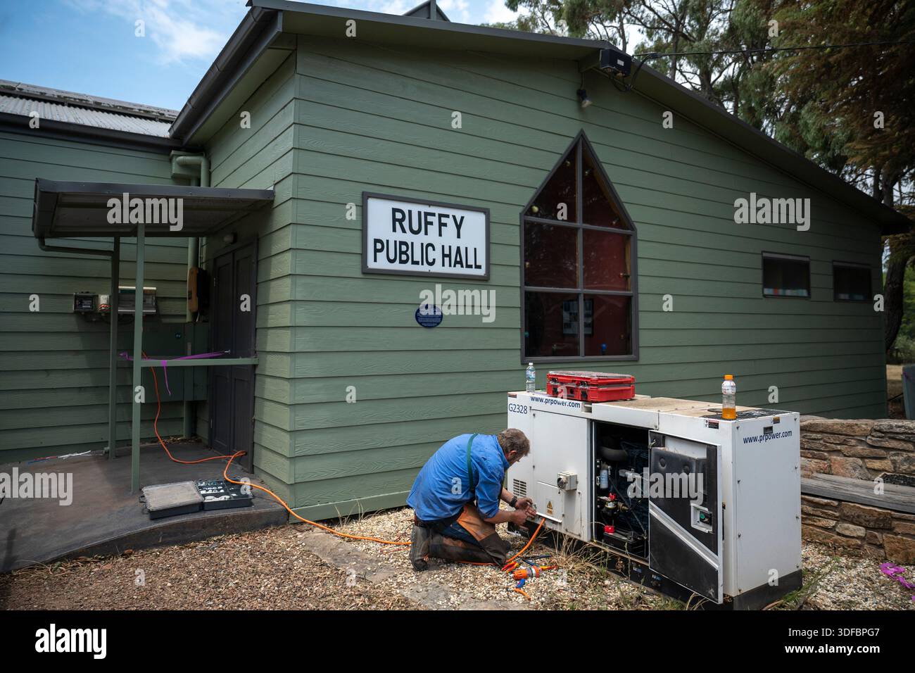 A resident in the bushfire-affected town of Ruffy works on restoring ...