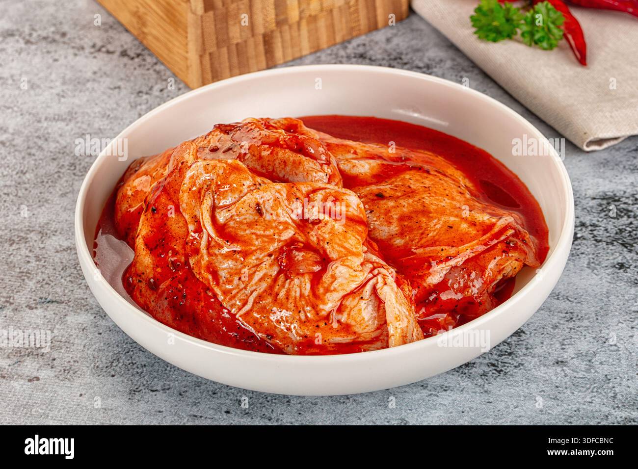 Raw chicken marinated thighs with skin for grill Stock Photo - Alamy