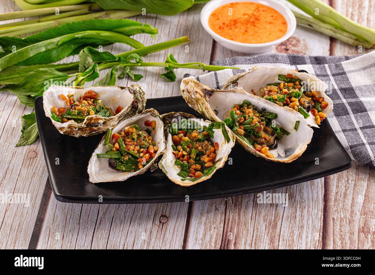 Gournet grilled oysters with green onion and peanut Stock Photo - Alamy