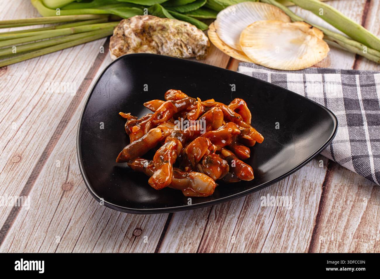 Razor shell mollusk with spicy sauce Stock Photo - Alamy