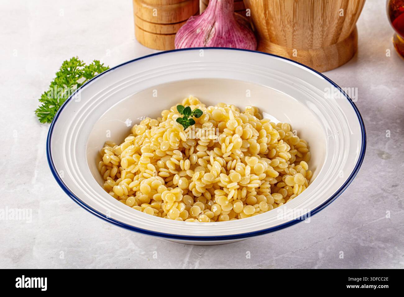 Boiled ptitim grain wheat pasta in the bowl Stock Photo - Alamy