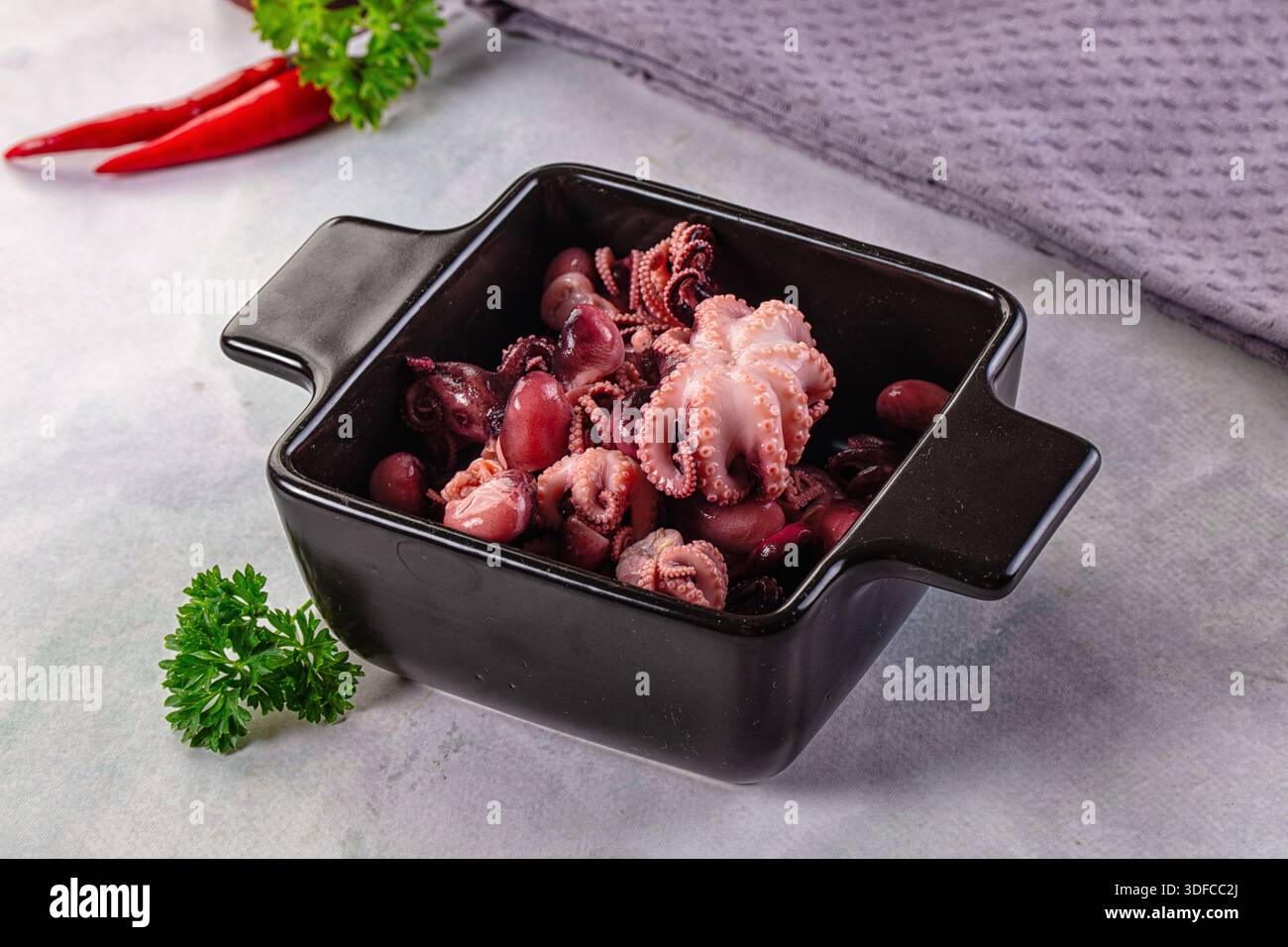 Marinated canned mini baby octopus in the bowl Stock Photo - Alamy