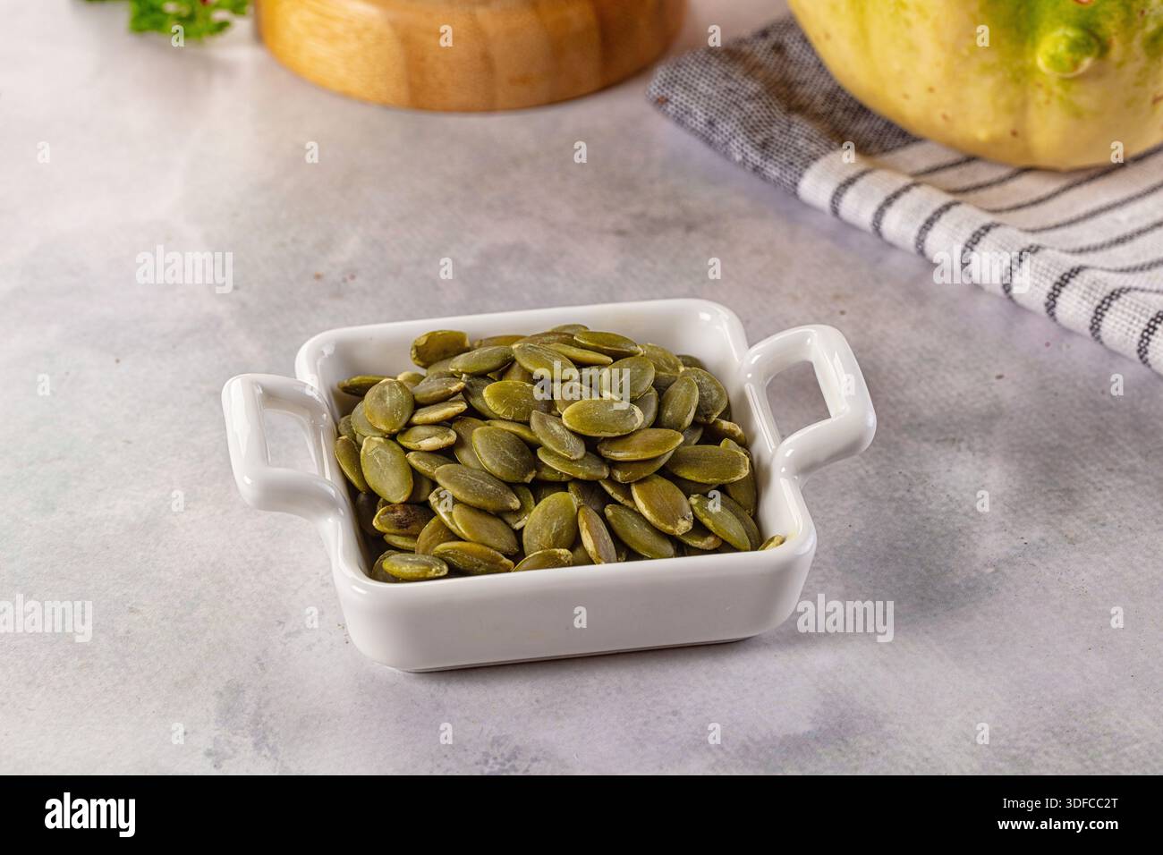 Fresh green pumpkin peeled seeds in the bowl Stock Photo - Alamy
