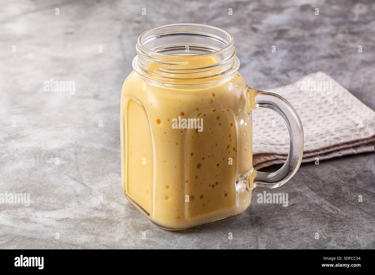 Sweet cold mango smoothie dessert glass Stock Photo - Alamy