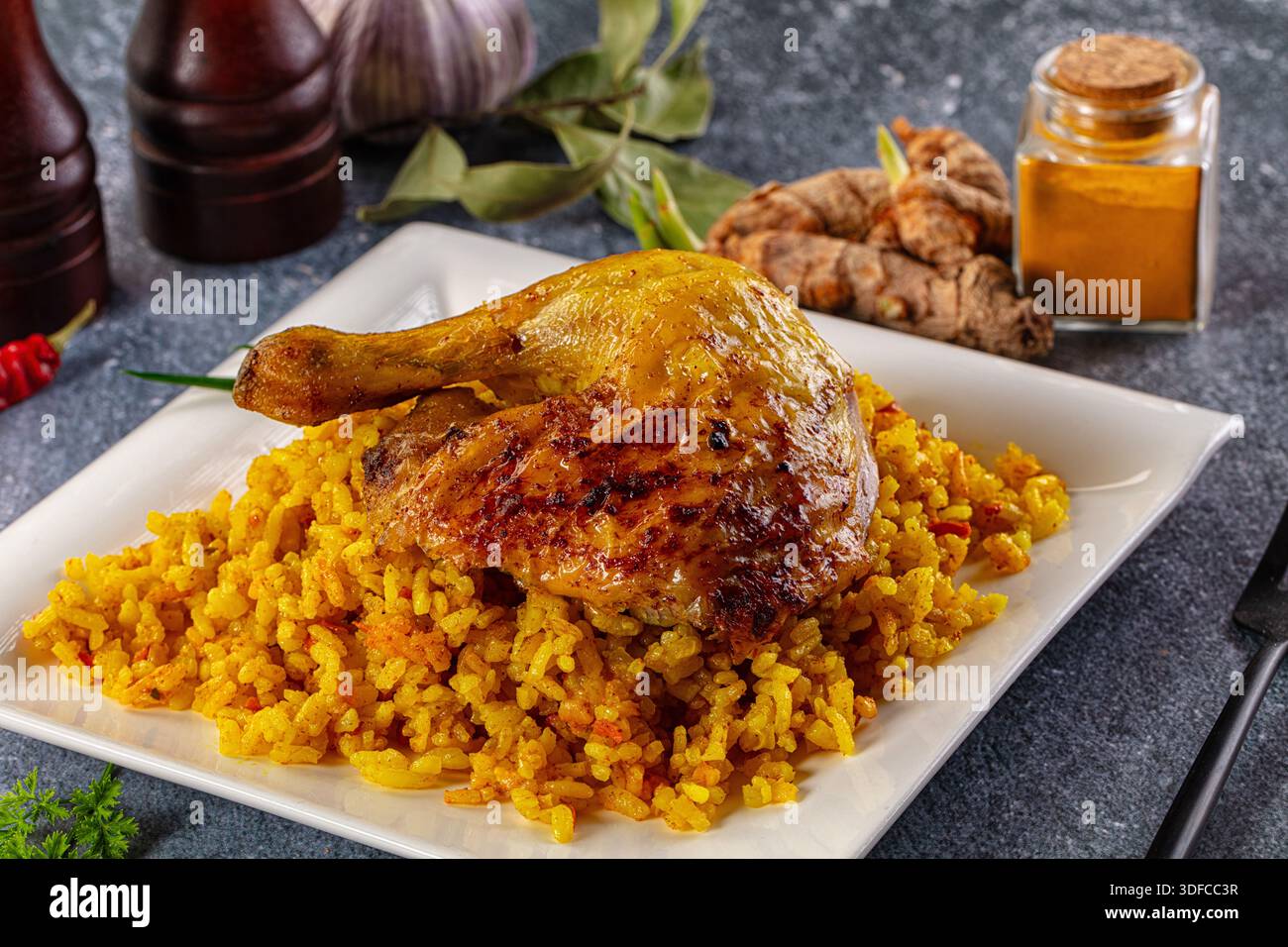 Roasted chicken leg with yellow curry rice Stock Photo - Alamy