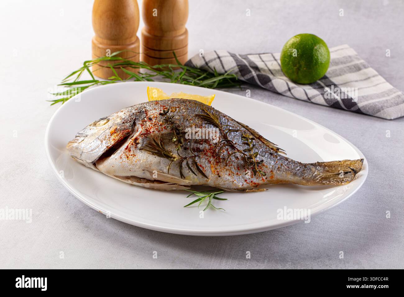 Baked dorada fish with spices and herbs Stock Photo - Alamy