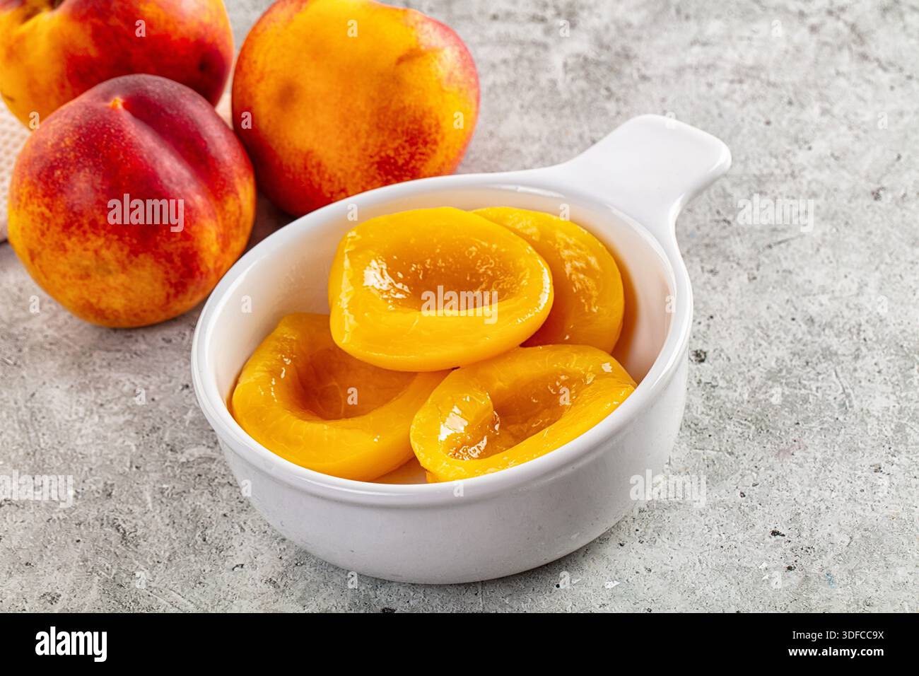 Sweet juicy canned peaches dessert snack Stock Photo - Alamy