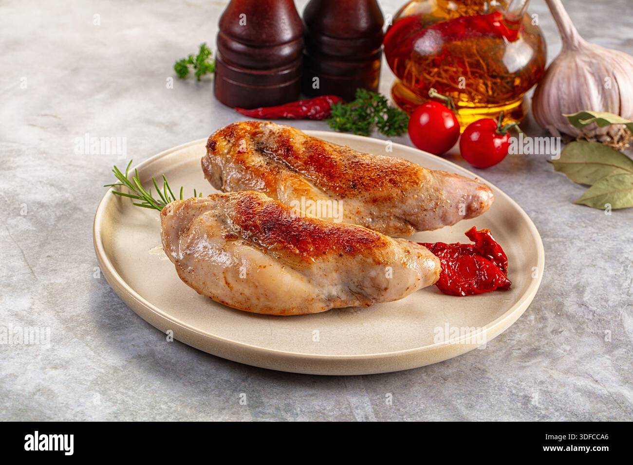 Roasted rabbit leg served rosemary in the plate Stock Photo - Alamy