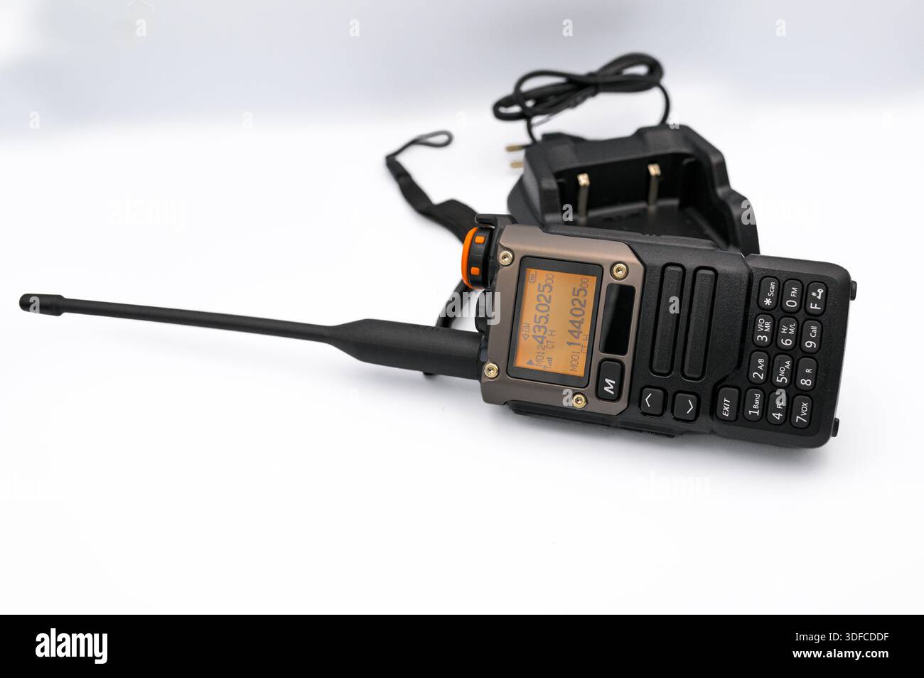 Handheld two way radio with long antenna showing frequency readout ...