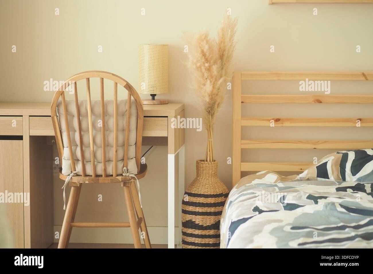 Simple room with chair, desk, and bed in neutral tones Stock Photo - Alamy